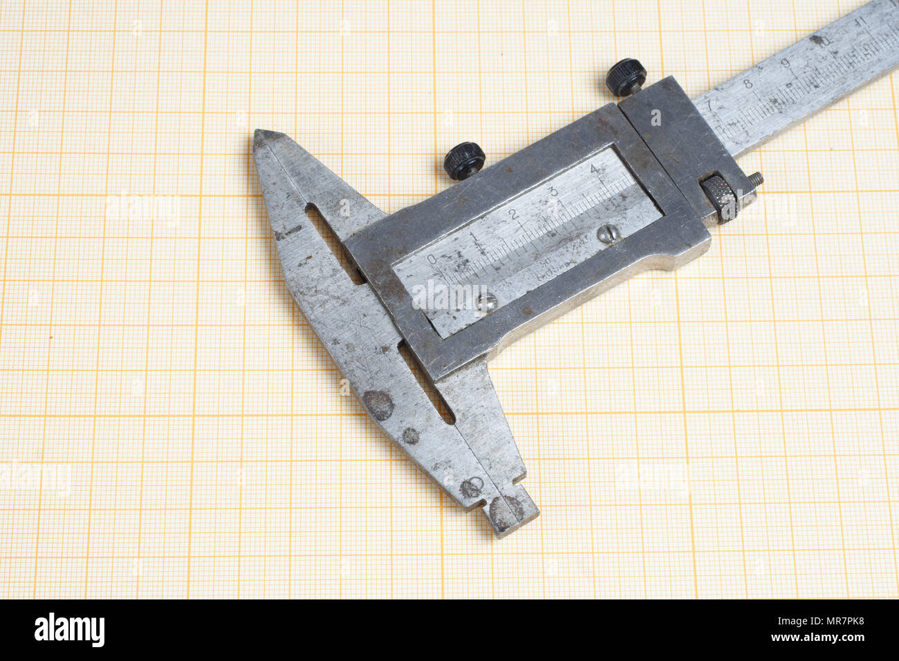 caliper on graph paper background Stock Photo - Alamy