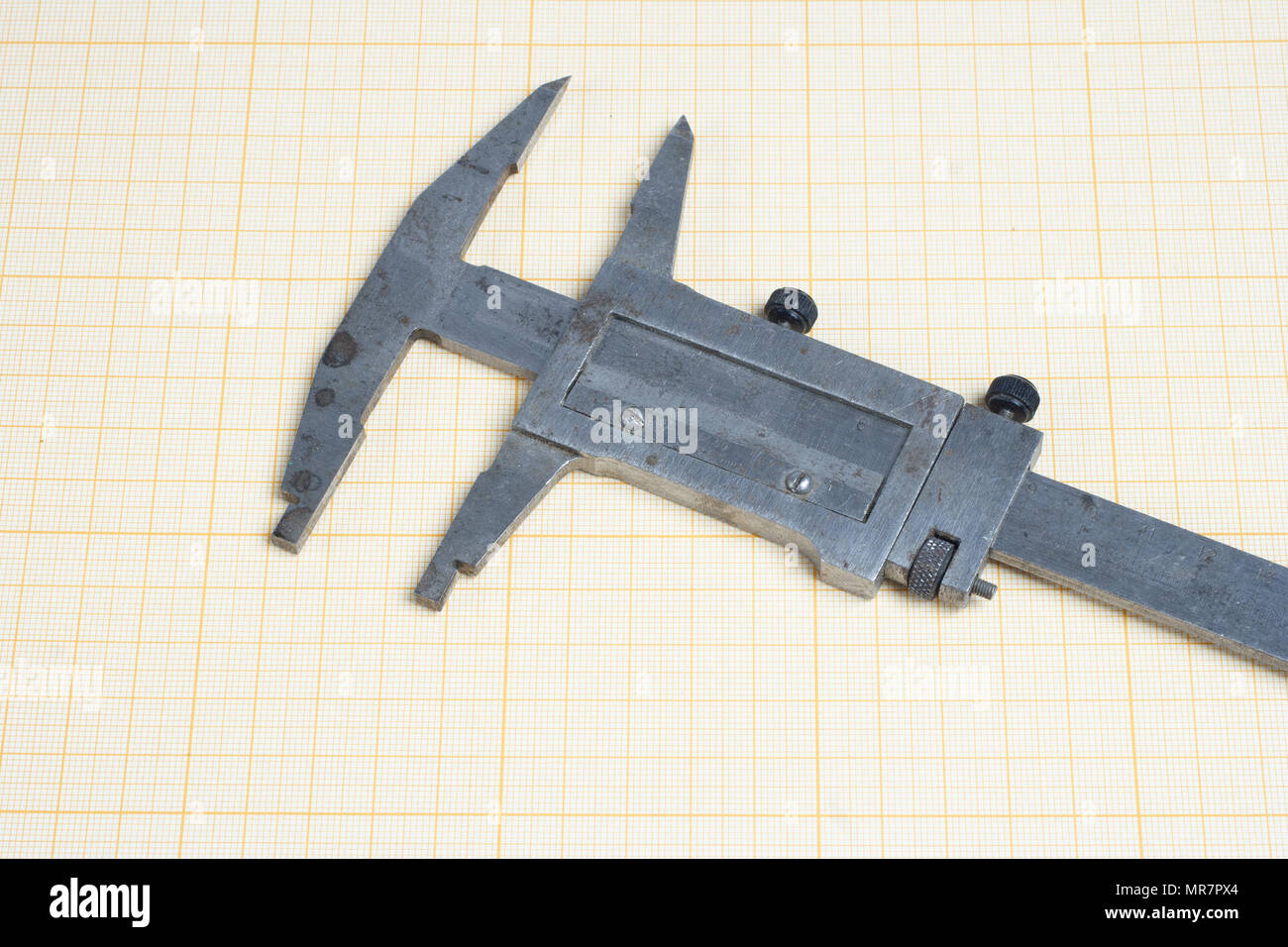 caliper on graph paper background Stock Photo - Alamy