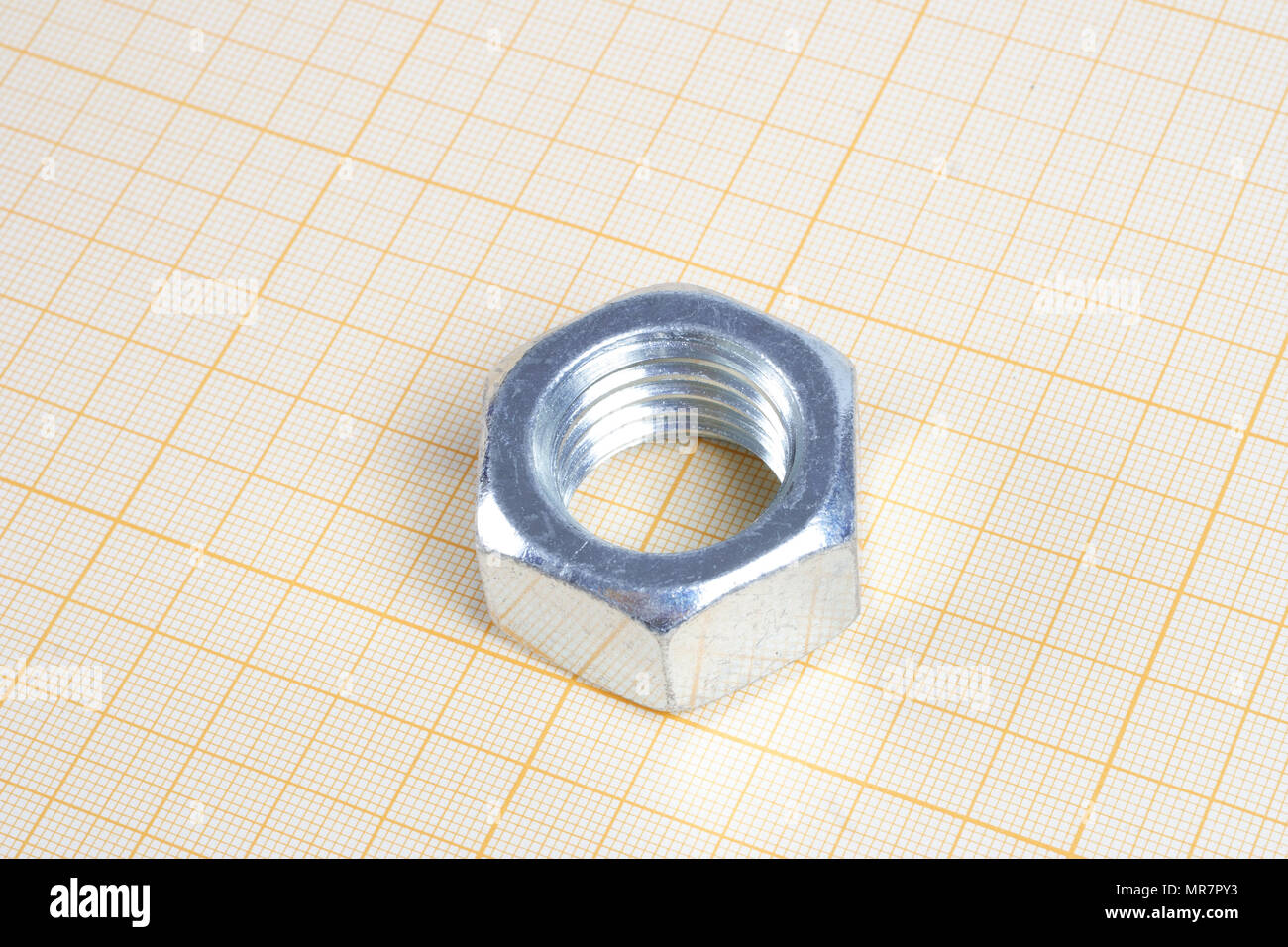 Screw, Nuts and caliper on graph paper background Stock Photo - Alamy