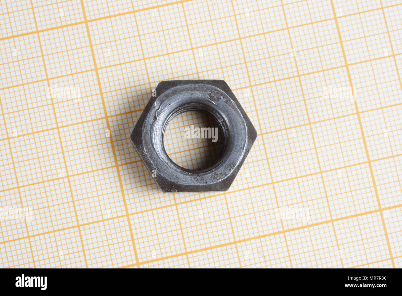 Screw, Nuts and caliper on graph paper background Stock Photo - Alamy