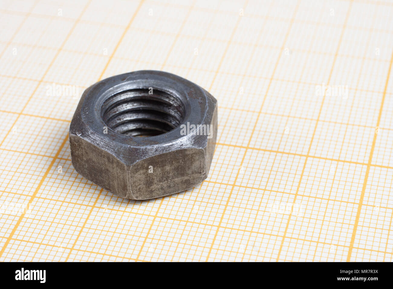 Screw, Nuts and caliper on graph paper background Stock Photo - Alamy