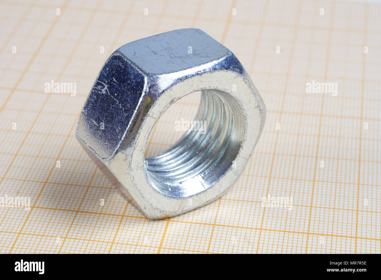 Screw, Nuts and caliper on graph paper background Stock Photo - Alamy