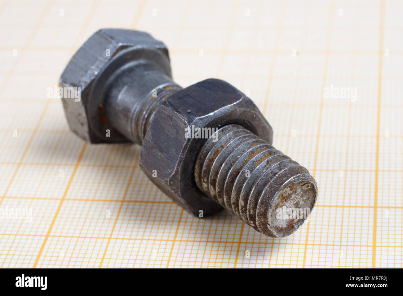 Screw, Nuts and caliper on graph paper background Stock Photo - Alamy