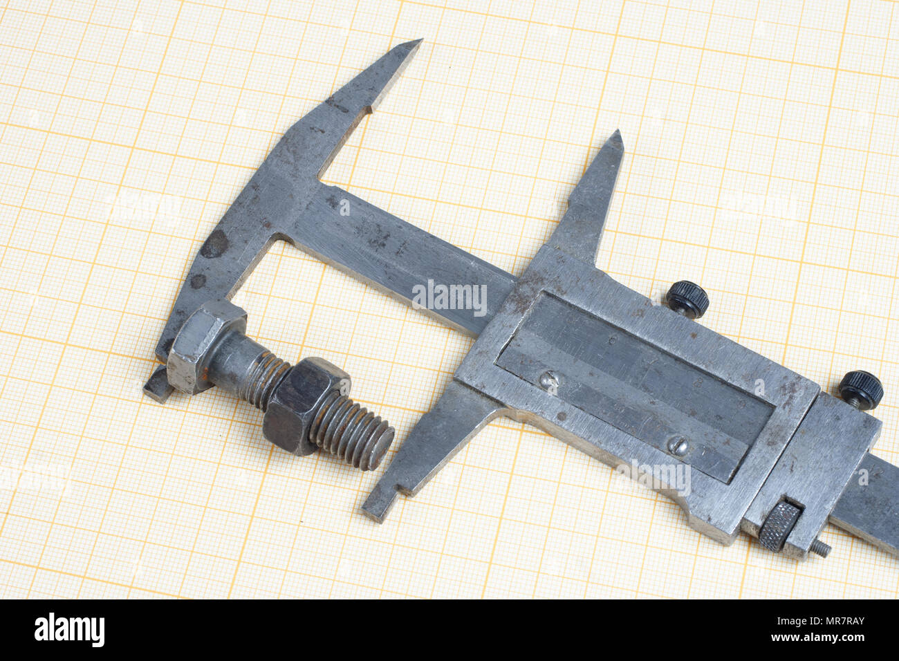 Screw, Nuts and caliper on graph paper background Stock Photo - Alamy