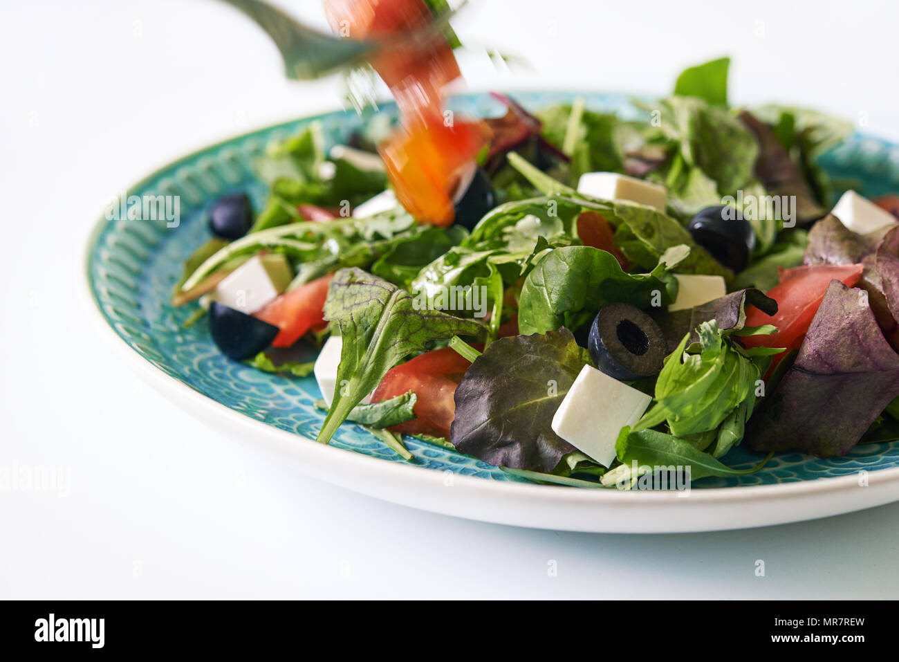 plate of green fresh mixed salad on light background Stock Photo - Alamy