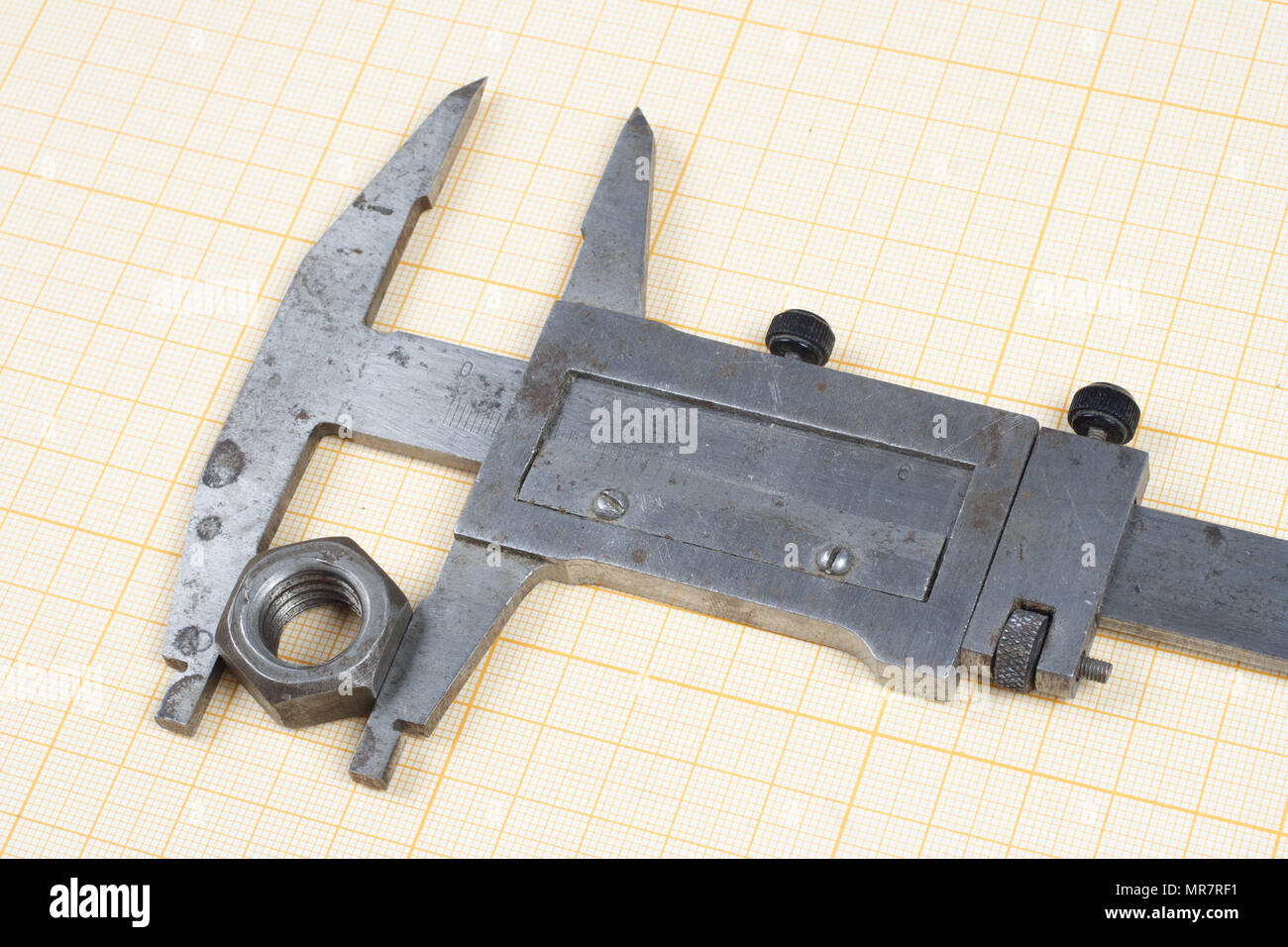 Screw, Nuts and caliper on graph paper background Stock Photo - Alamy