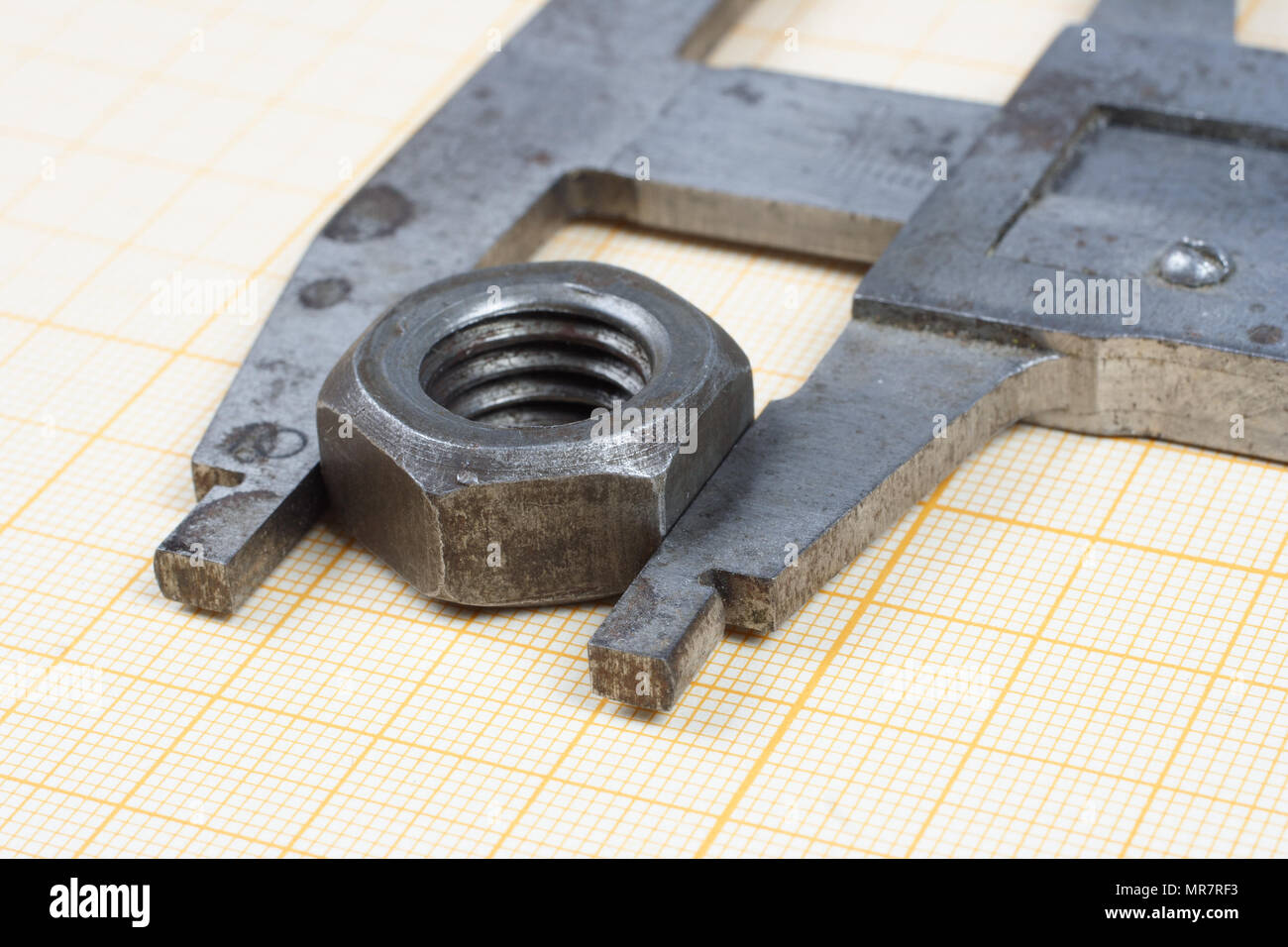 Screw, Nuts and caliper on graph paper background Stock Photo - Alamy
