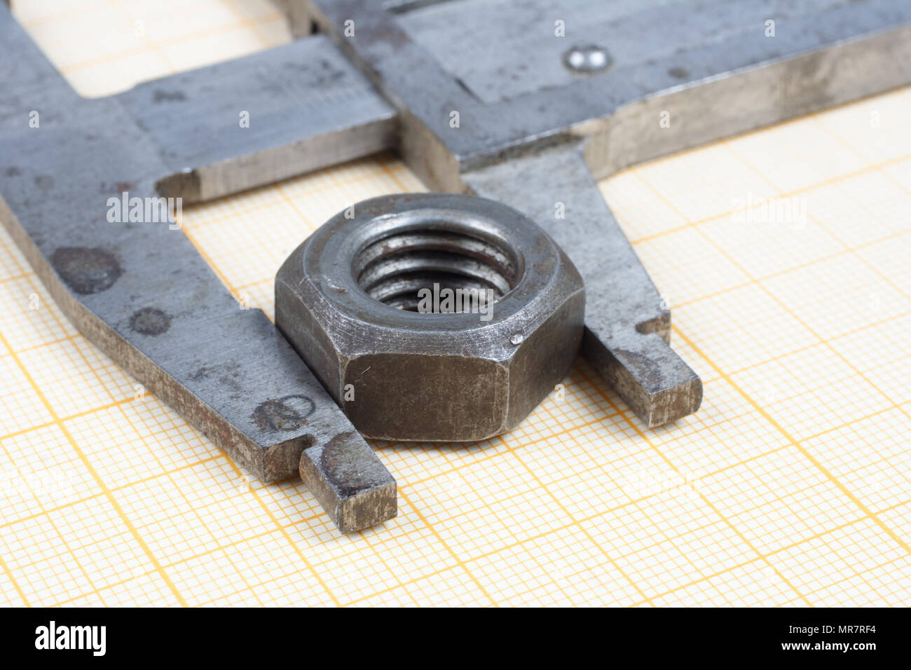 Screw, Nuts and caliper on graph paper background Stock Photo - Alamy