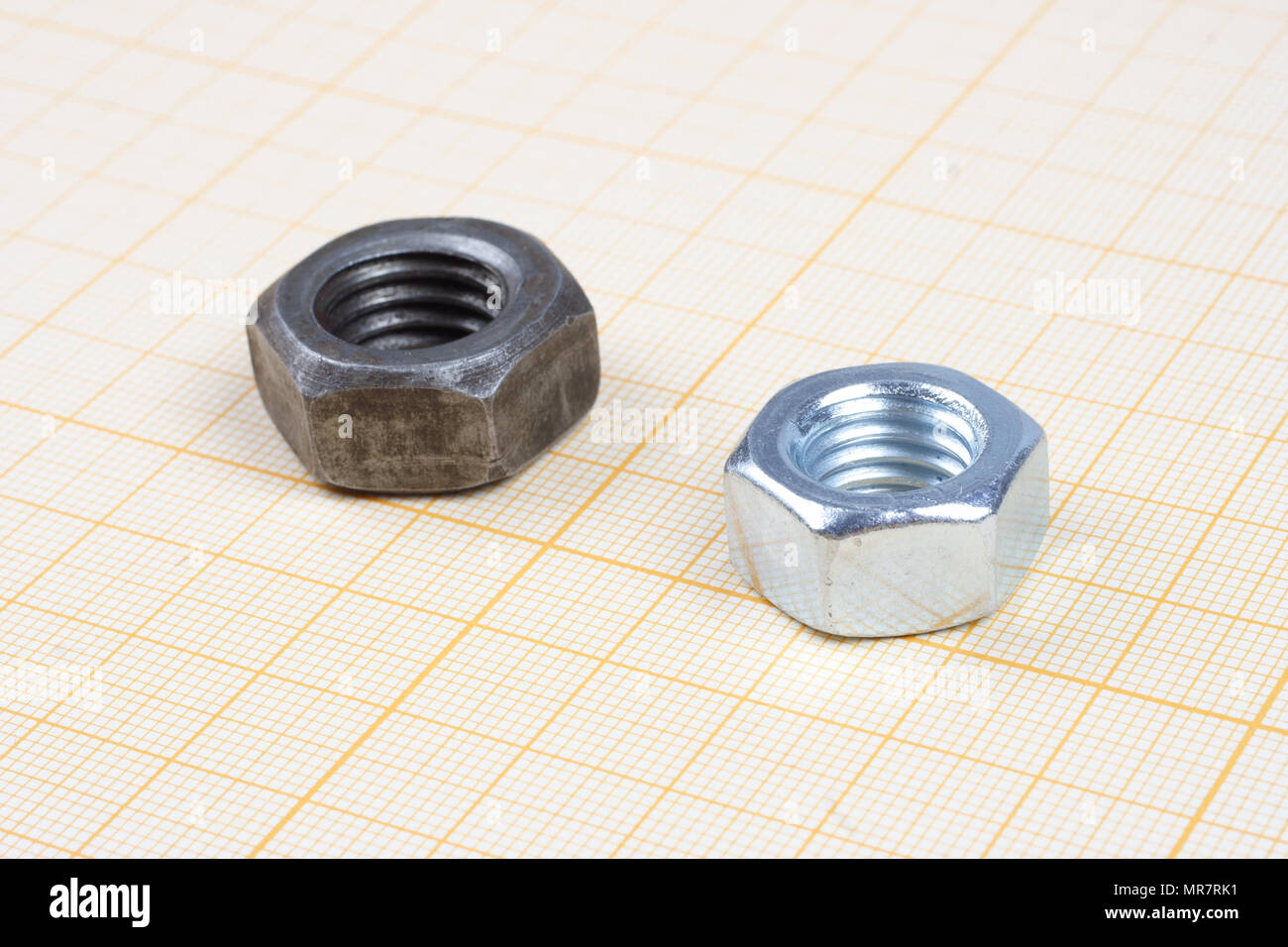 Screw, Nuts on graph paper background Stock Photo - Alamy
