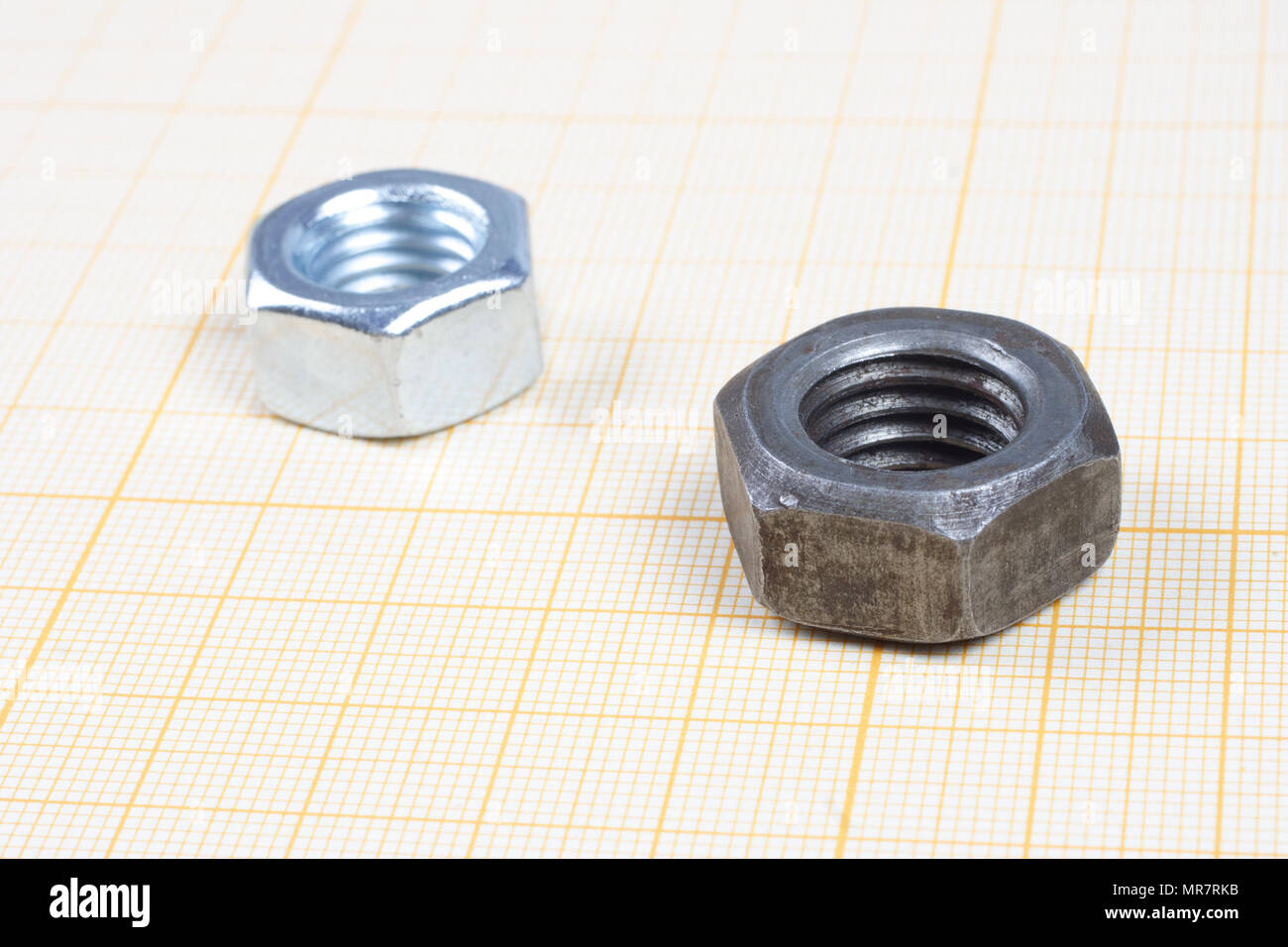 Screw, Nuts on graph paper background Stock Photo - Alamy