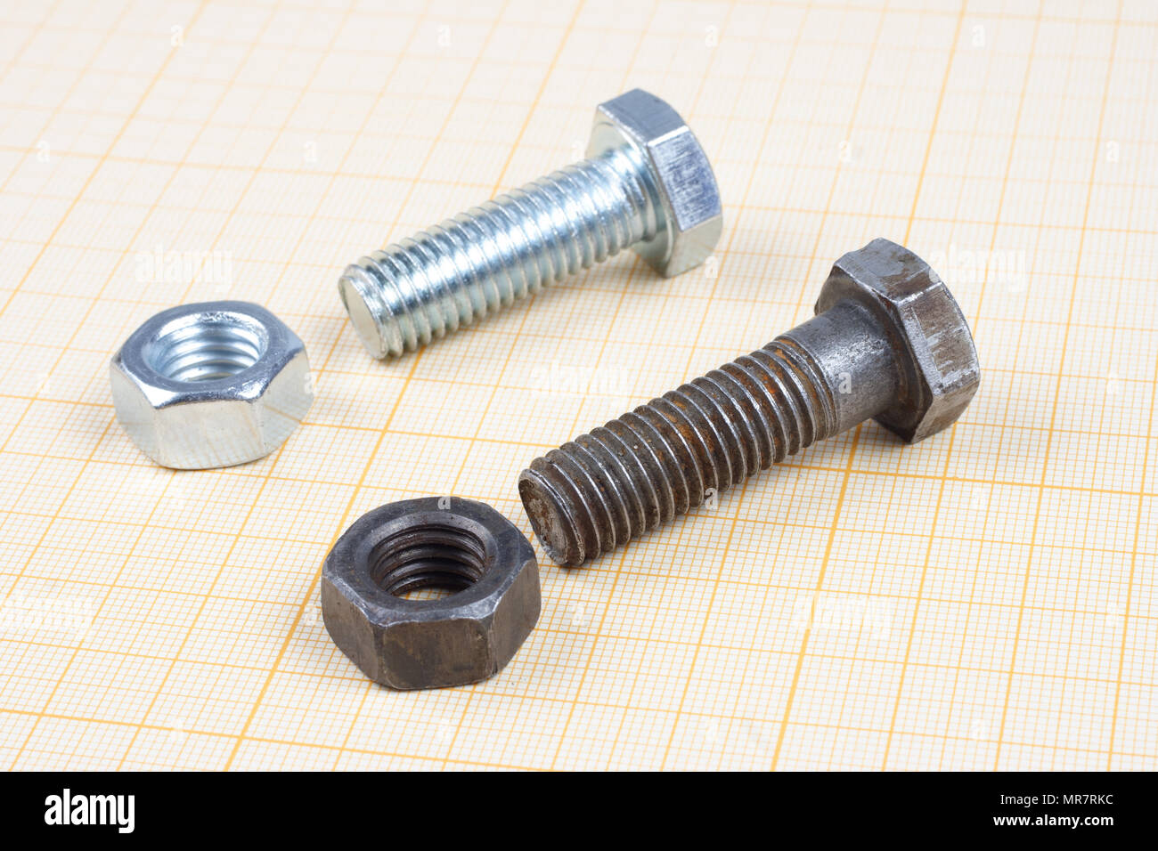 Screw, Nuts on graph paper background Stock Photo - Alamy