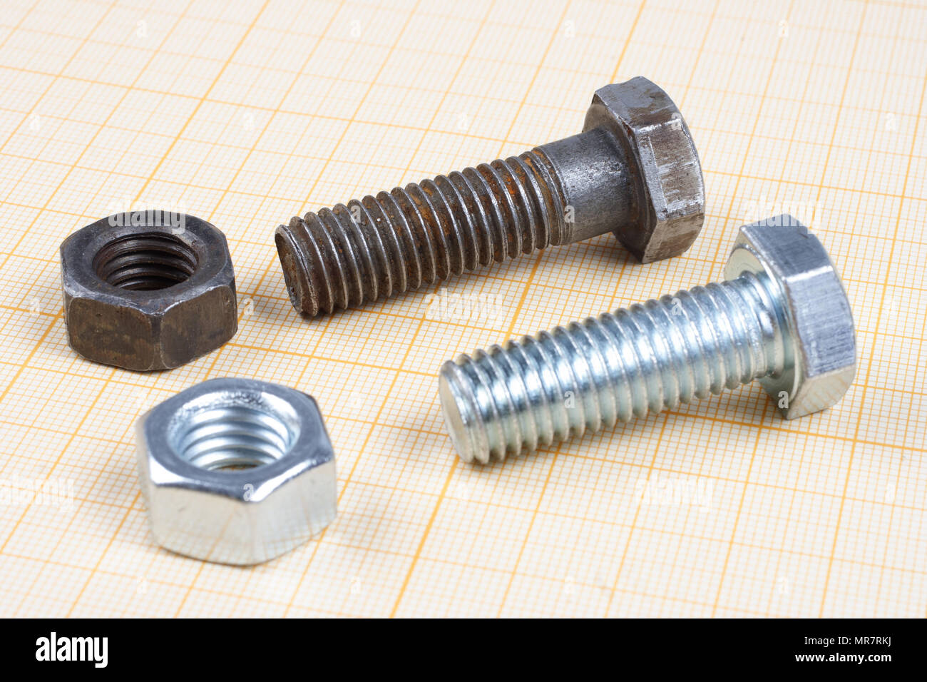 Screw, Nuts on graph paper background Stock Photo - Alamy