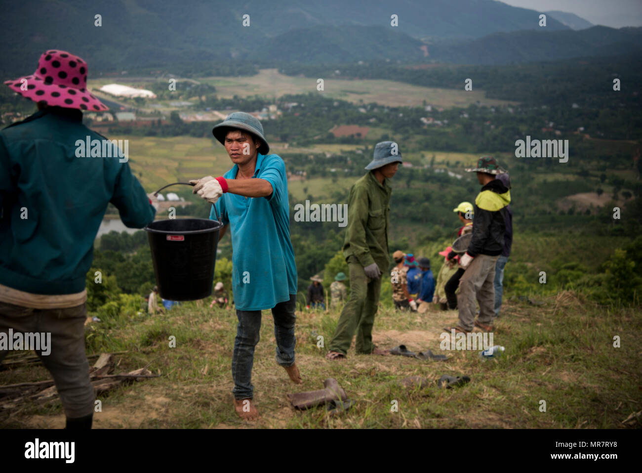 Local Vietnamese villagers form a bucket line to aid the Defense POW ...