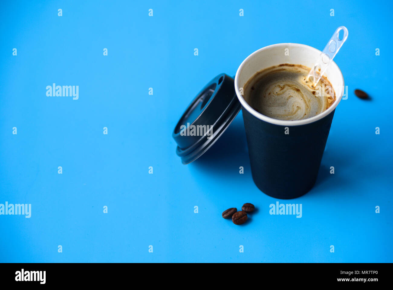 Instant coffee in paper cup with cap on light blue pastel background ...