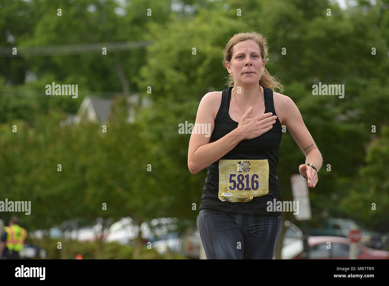 33 year-old runner Amy Blue of Munster, Indiana, puts her hand over her ...