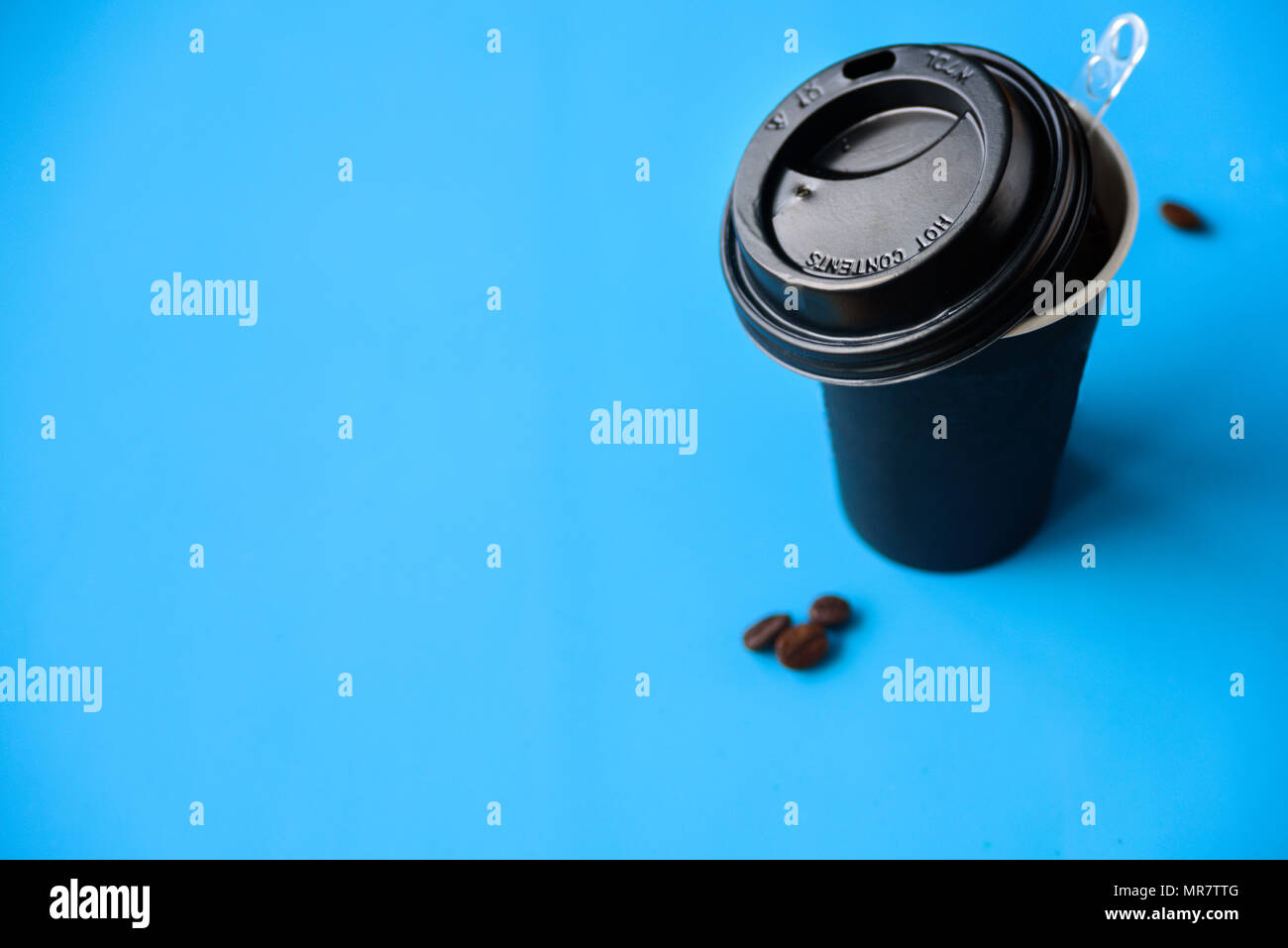 Instant coffee in paper cup with cap on light blue pastel background ...
