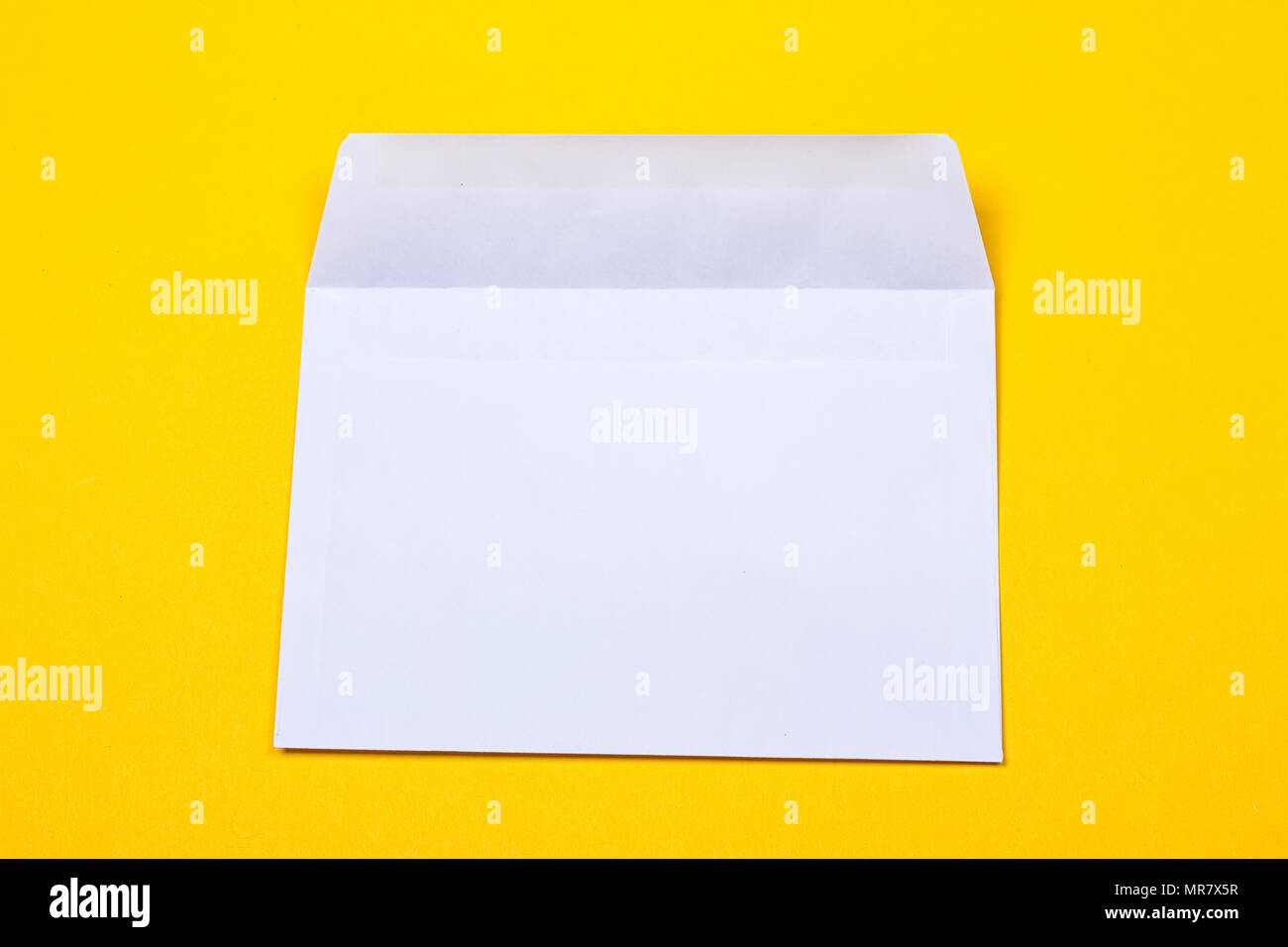 white open envelopes on the yellow background Stock Photo - Alamy