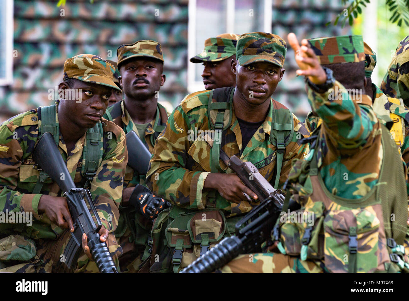 A Ghana Armed Forces soldier gives intructons to his squad while ...