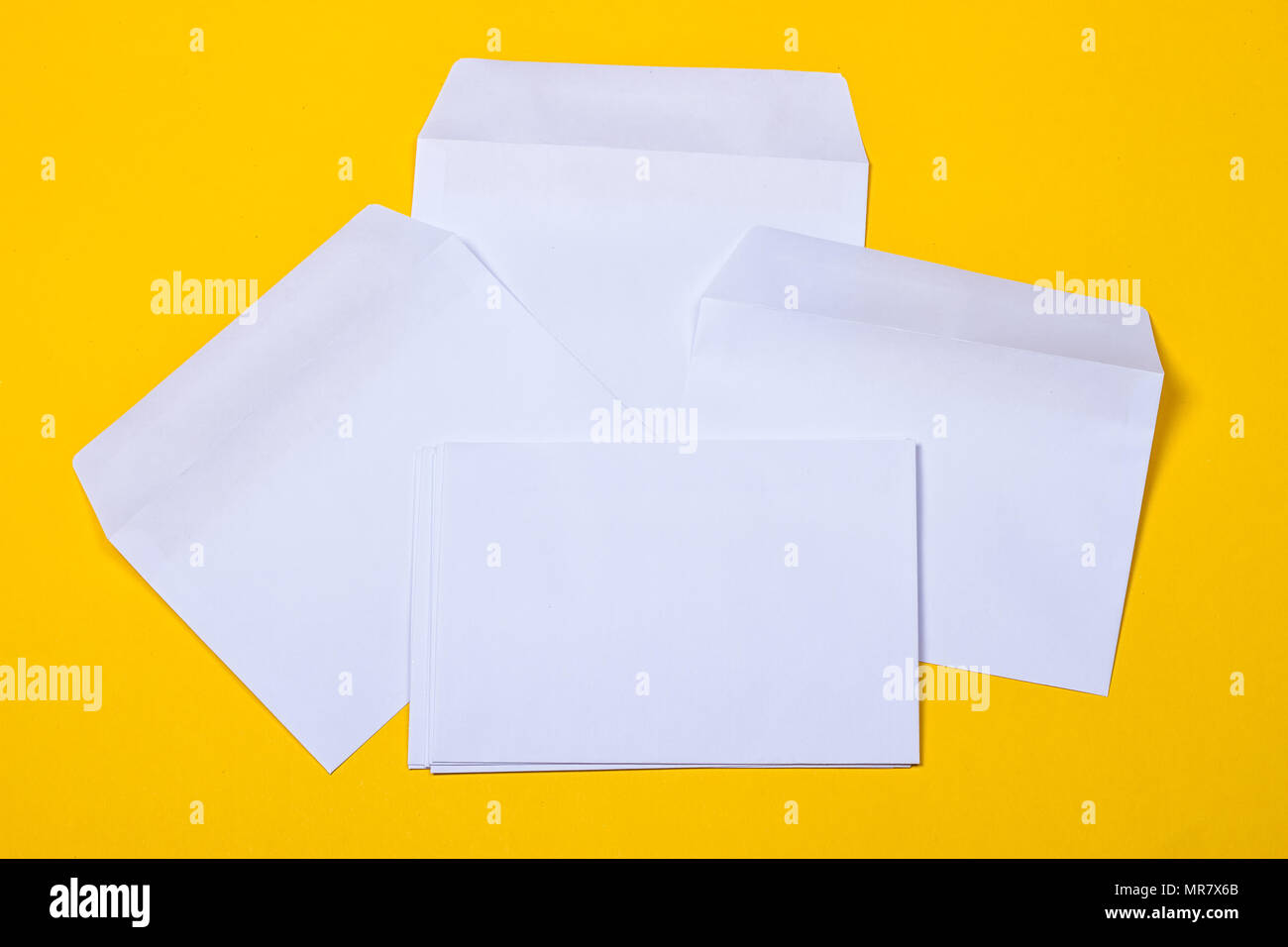 white open envelopes on the yellow background Stock Photo - Alamy