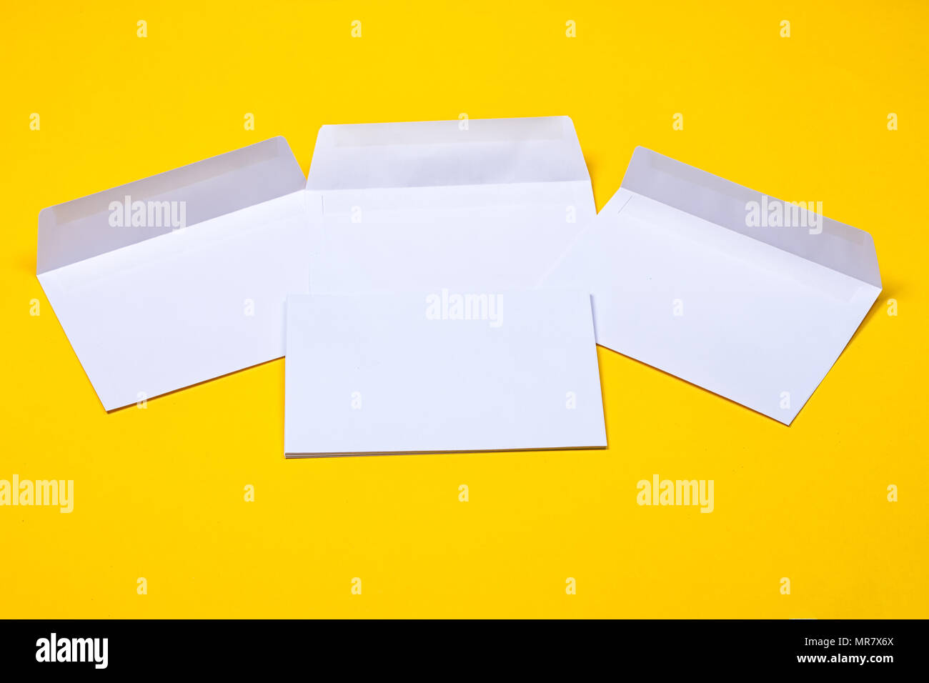 white open envelopes on the yellow background Stock Photo - Alamy