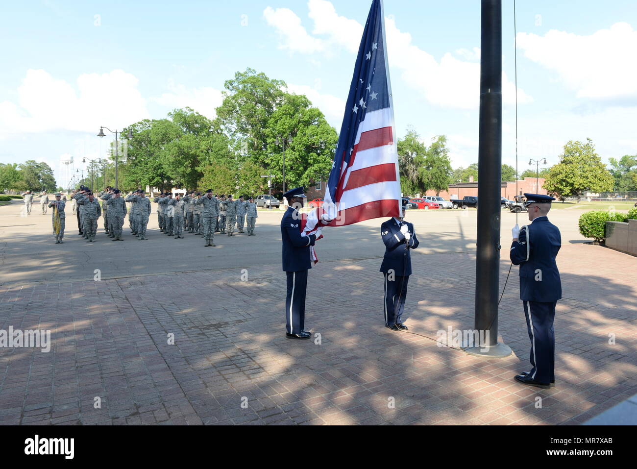 The 14th Security Forces Squadron salutes the flag during a retreat ...