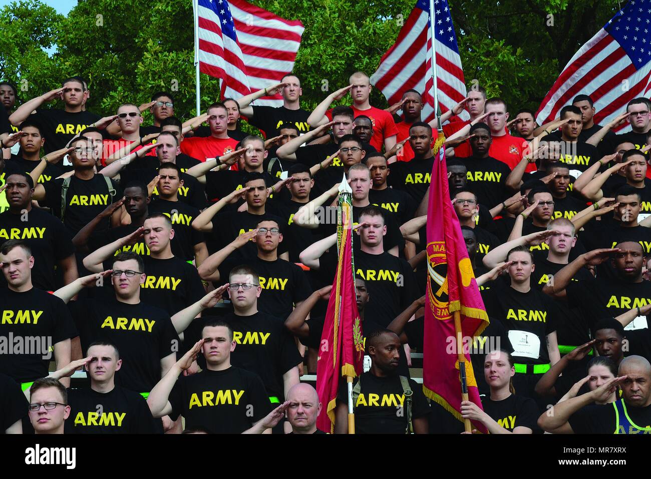 Soldiers salute the ensign as the National Anthem is being performed by ...