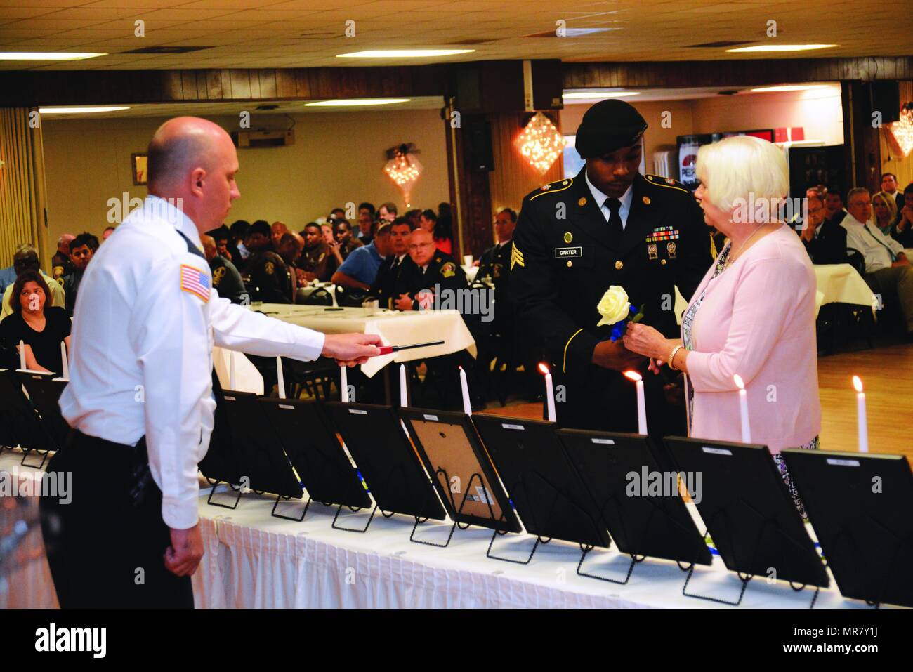 A candle is being lit by Lt. Tim Wilson, Provost Marshall Office for a ...