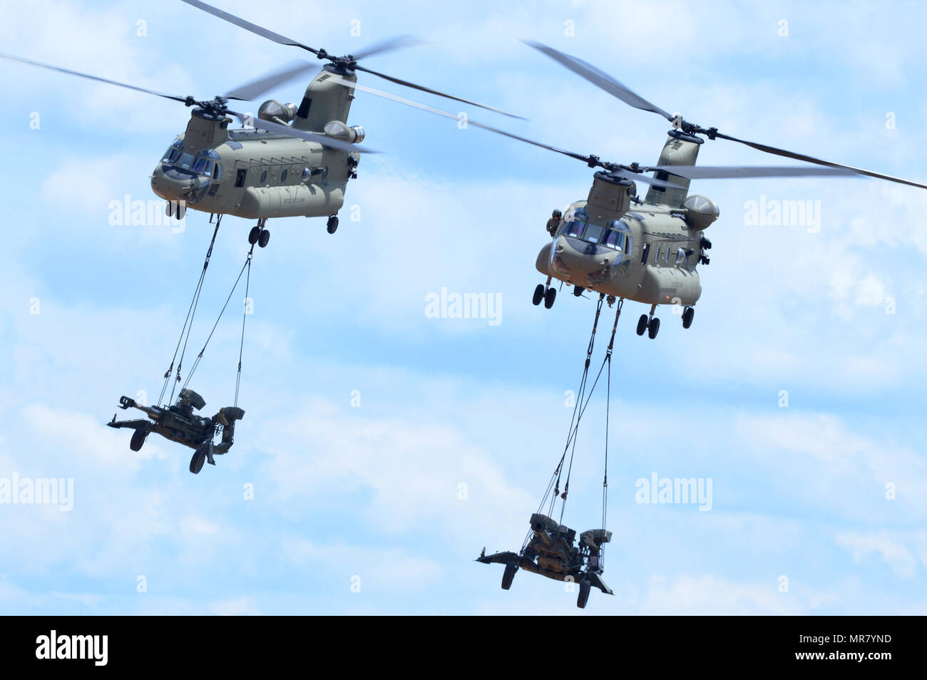 Two CH-47 Chinook helicopters fly into Sicily Drop Zone carrying M777 ...