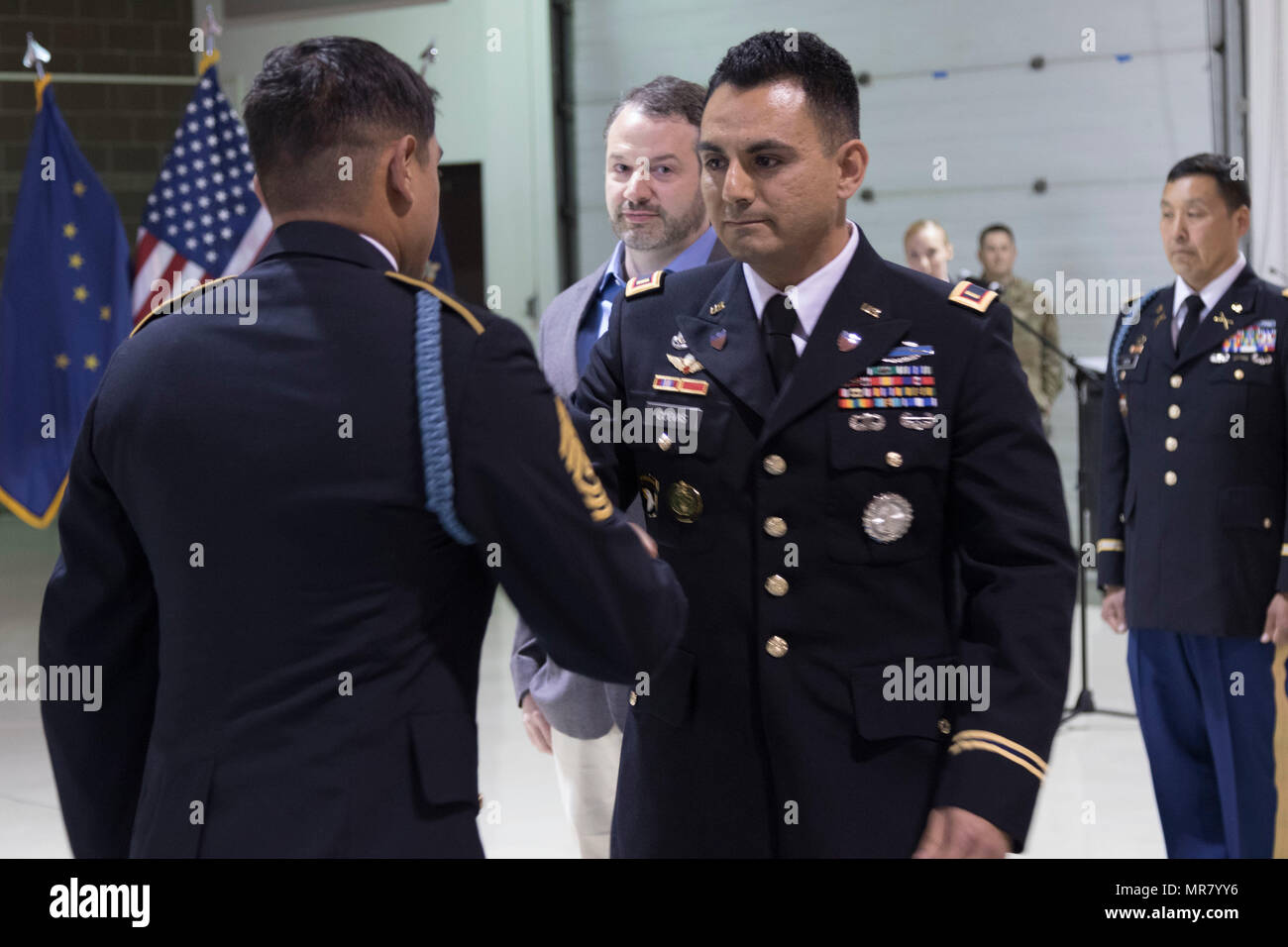 2nd Lt. Ivan Cuevas shakes hands with 1st Sgt. Sergio Silva, 140th ...