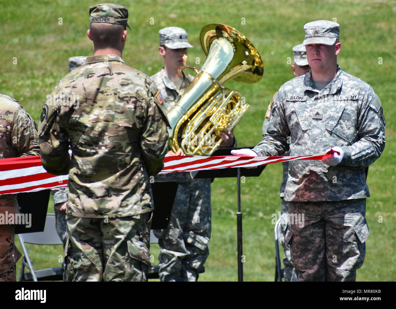 Members of the Iowa National Guard fold the flag as the band plays ...