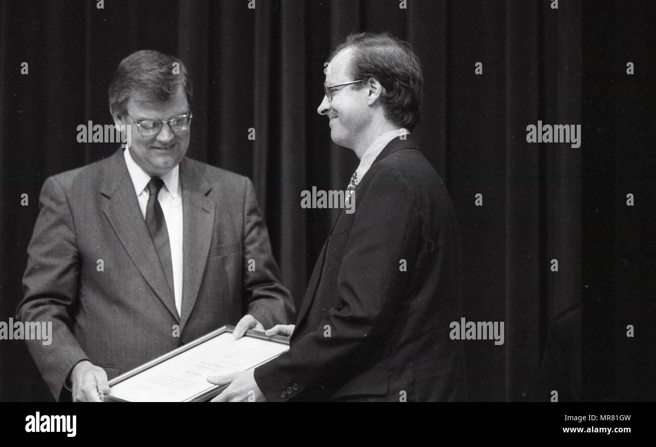 Admin. Atwood presenting general awards - Man receiving award on stage ...