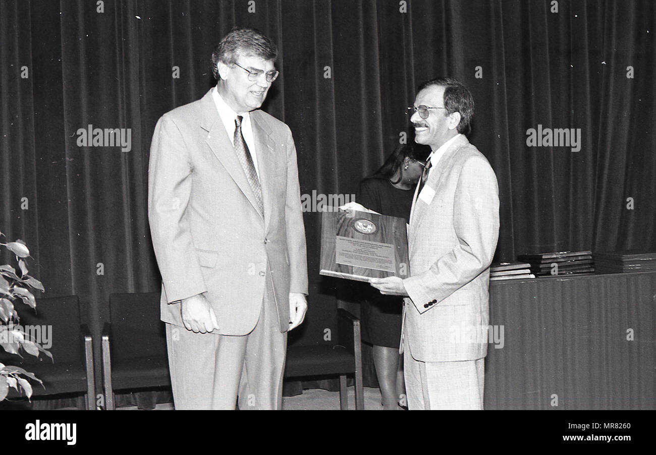 Admin. Atwood presenting general awards - Man receiving award on stage ...