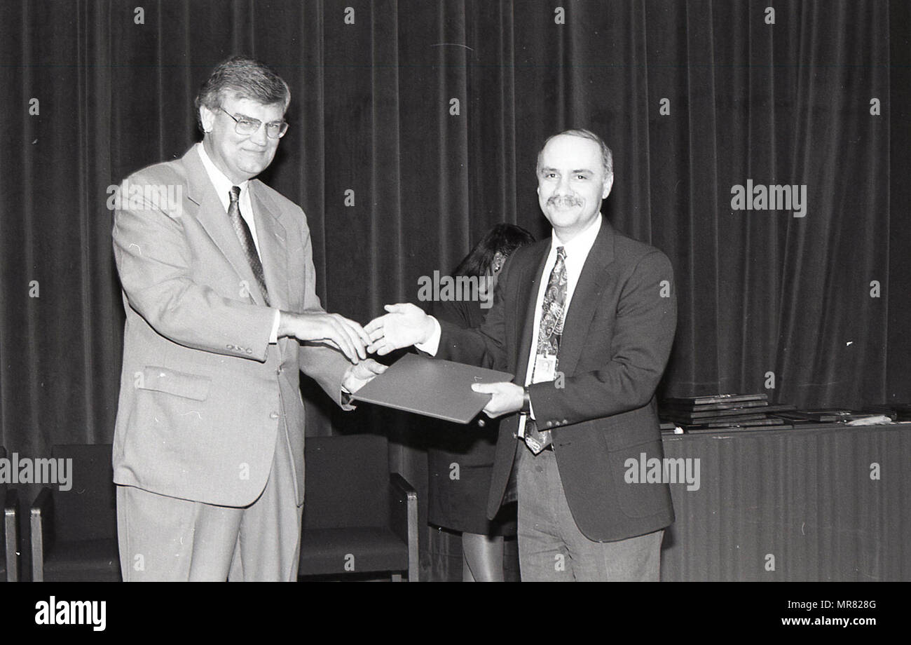 Admin. Atwood presenting general awards - Man receiving award on stage ...