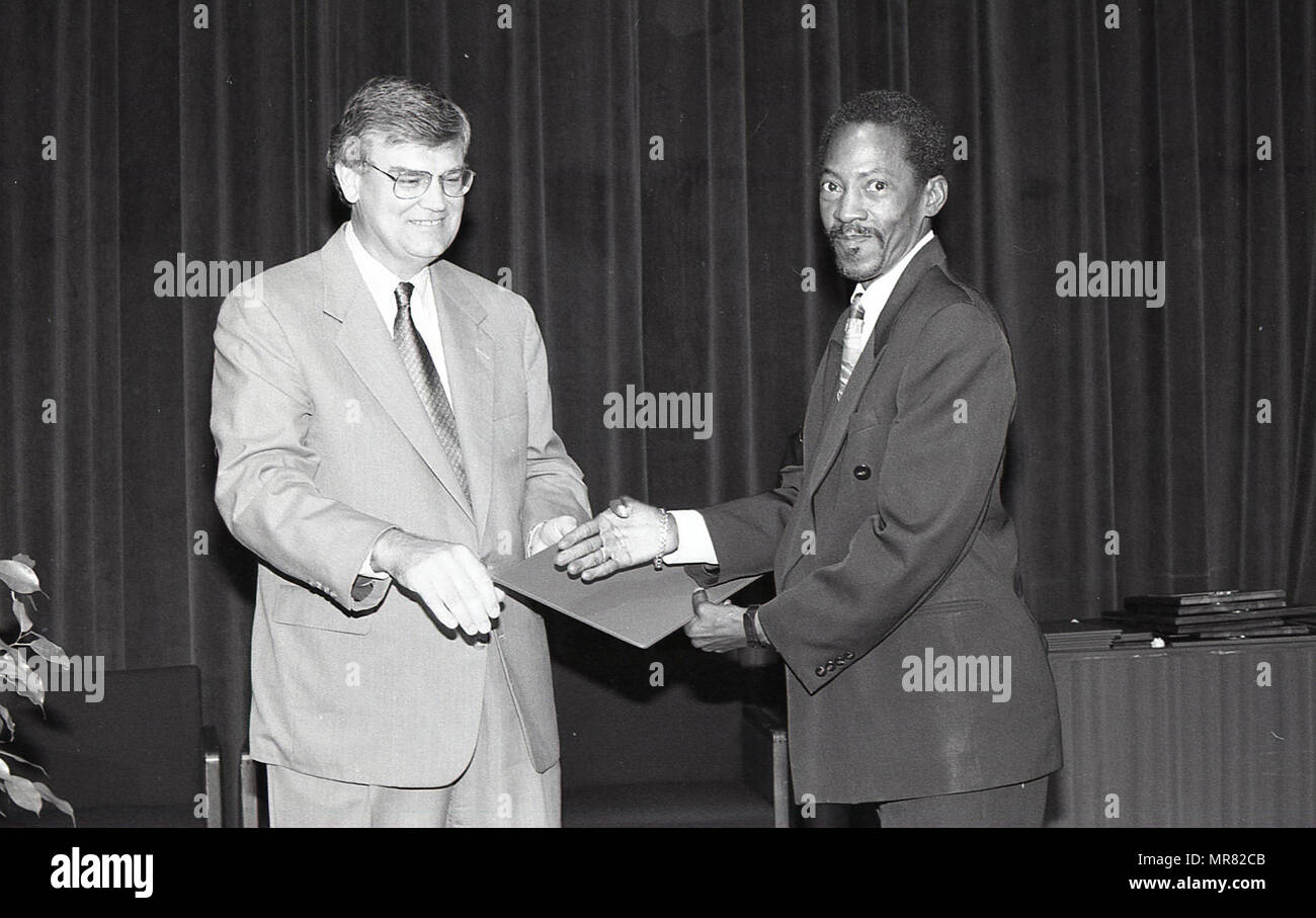 Admin. Atwood presenting general awards - Man receiving award on stage ...