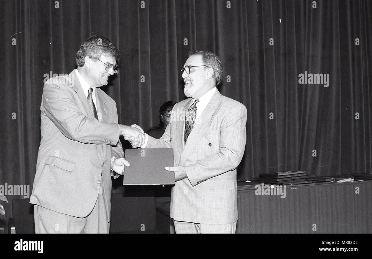 Admin. Atwood presenting general awards - Man receiving award on stage ...