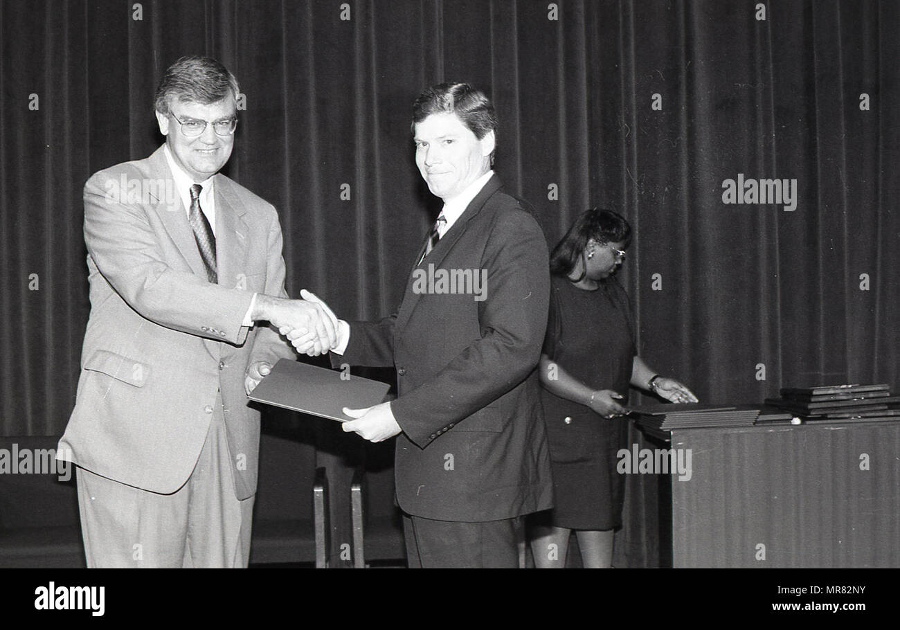 Admin. Atwood presenting general awards - Man receiving award on stage ...