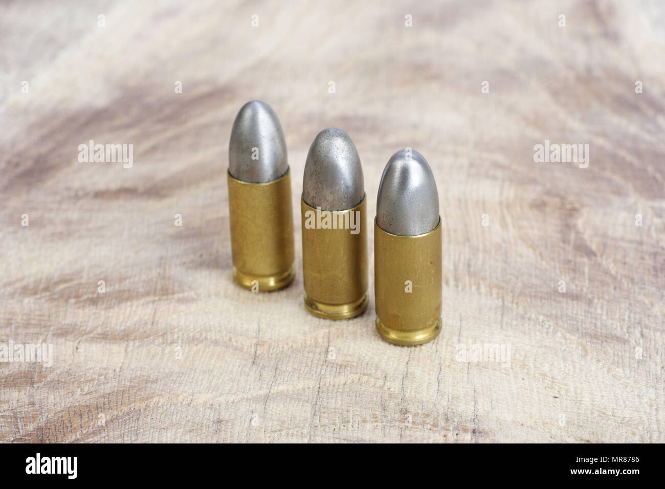 The 9mm caliber cartridge on wooden background Stock Photo - Alamy