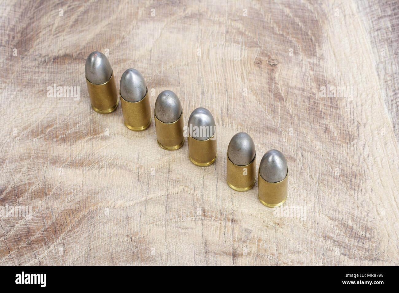 The 9mm caliber cartridge on wooden background Stock Photo - Alamy