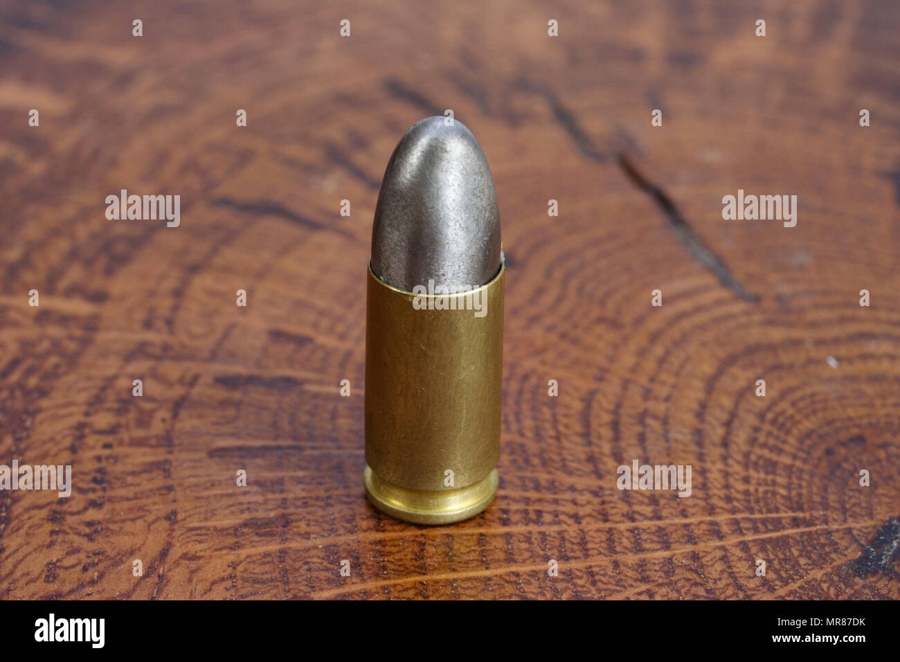 The 9mm caliber cartridge on wooden background Stock Photo - Alamy