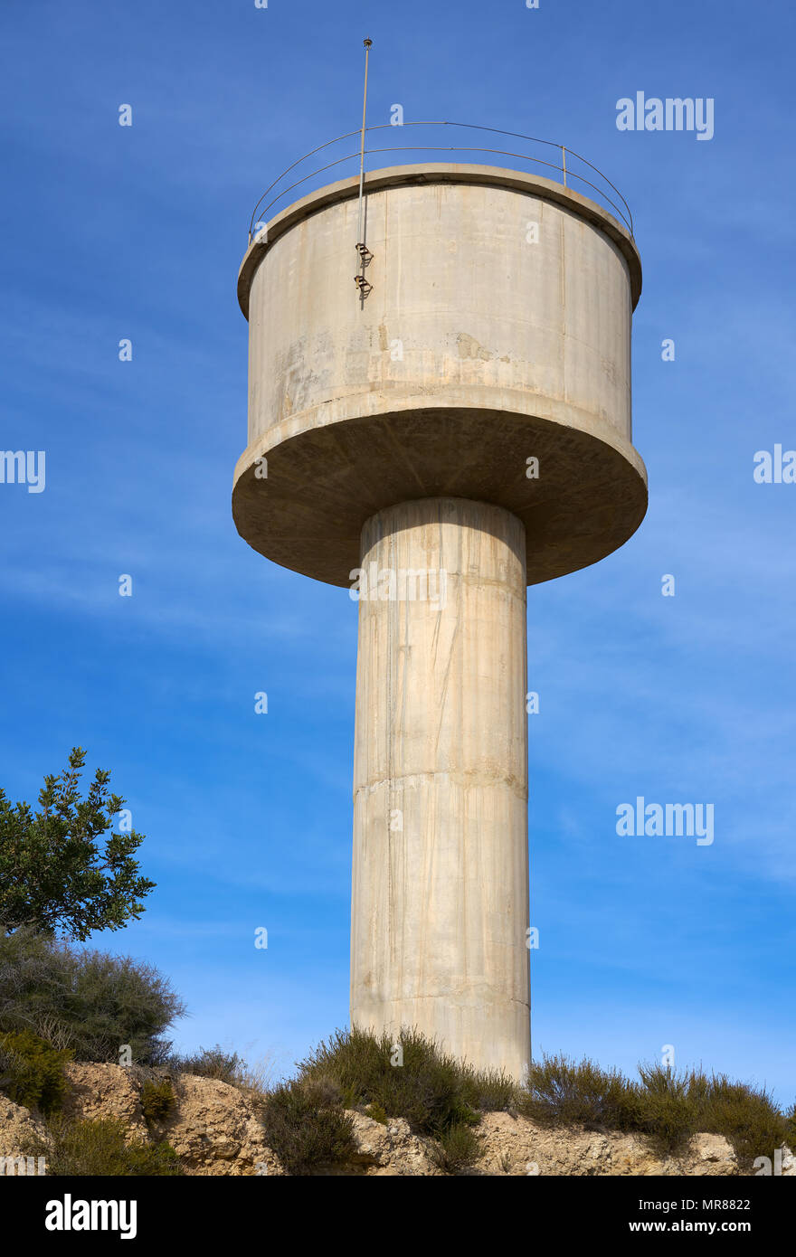 concrete water tower with blue sky background Stock Photo - Alamy