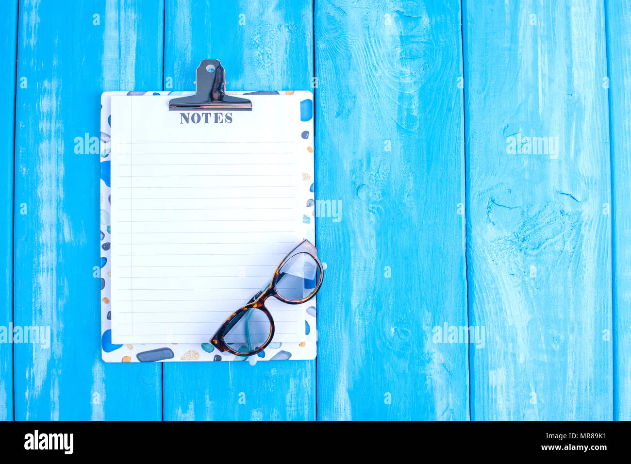 Flat lay design of work desk , glasses on and blue background Stock ...