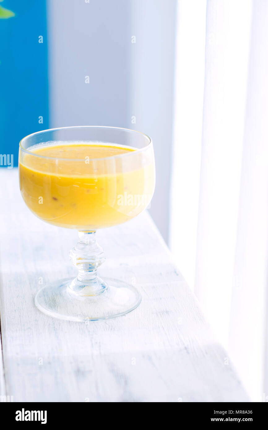 juice in glass and fresh fruits with leaves on wooden background ...