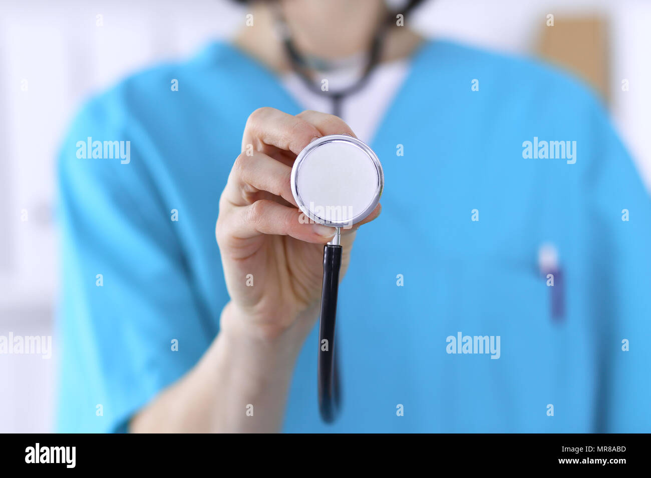Female doctor holds stethoscope head closeup. Physicians ready to ...
