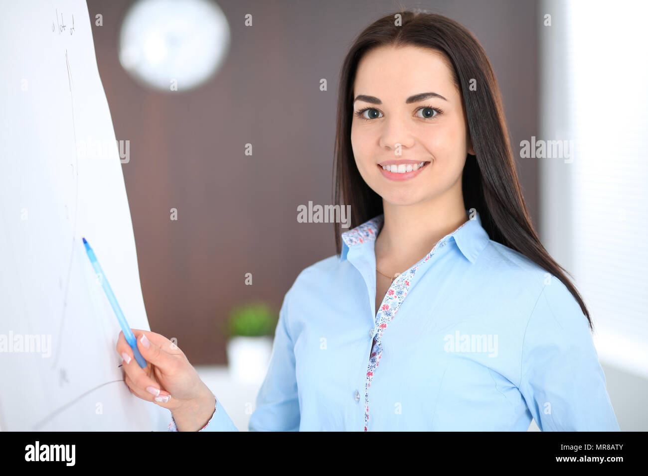 Young brunette business woman looks like a student girl working in ...