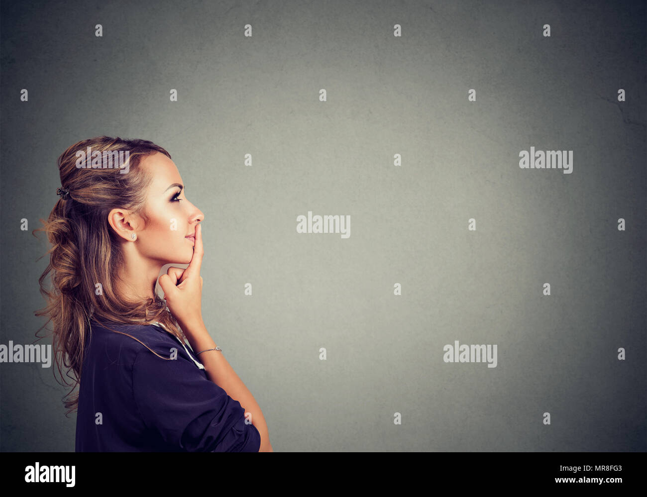Side view of a pretty brunette woman in contemplation looking away ...