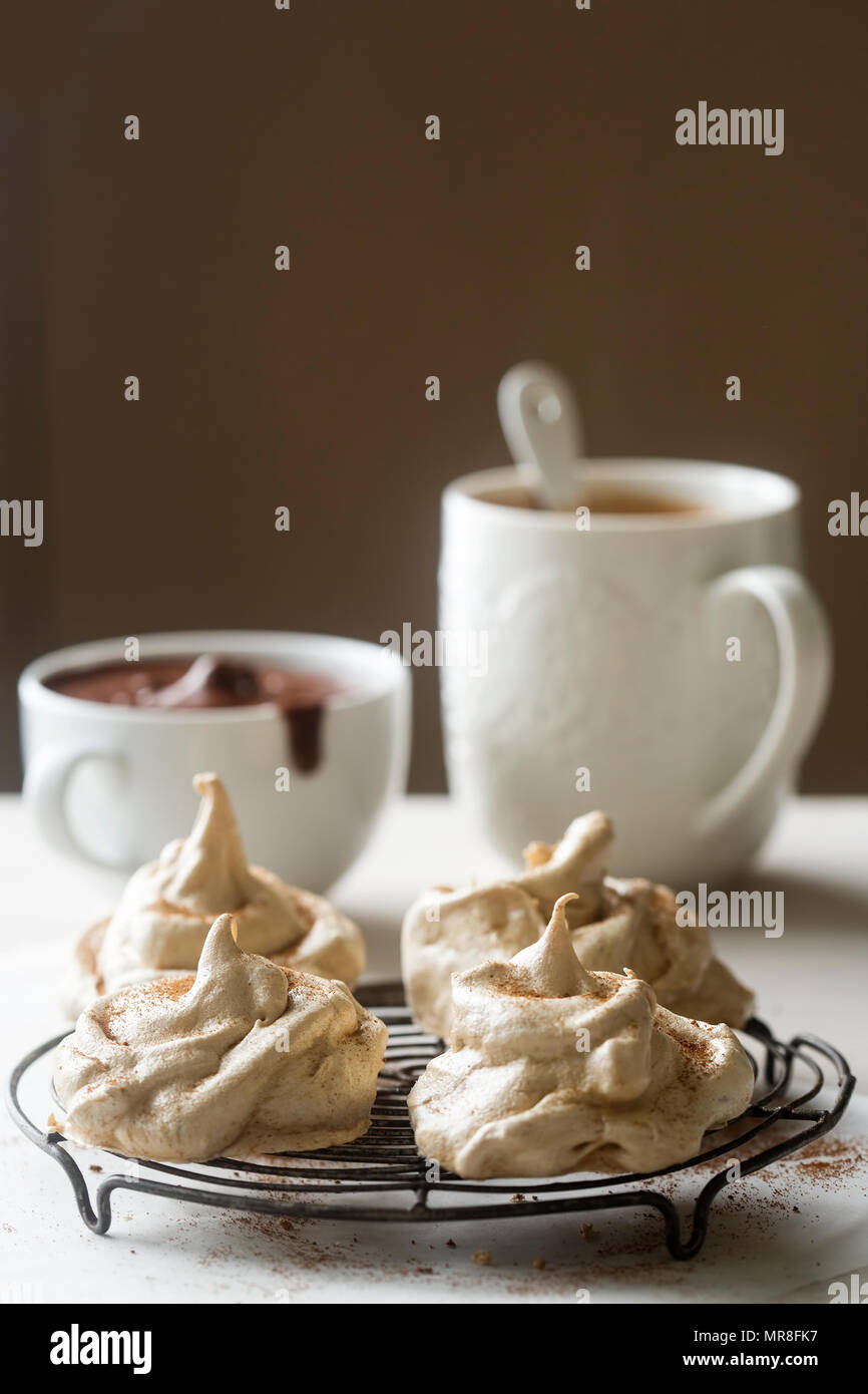 Coffee meringues with chocolate sauce Stock Photo - Alamy