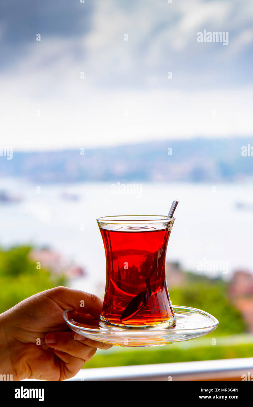 Anonymous hand servicing Turkish Tea Stock Photo - Alamy