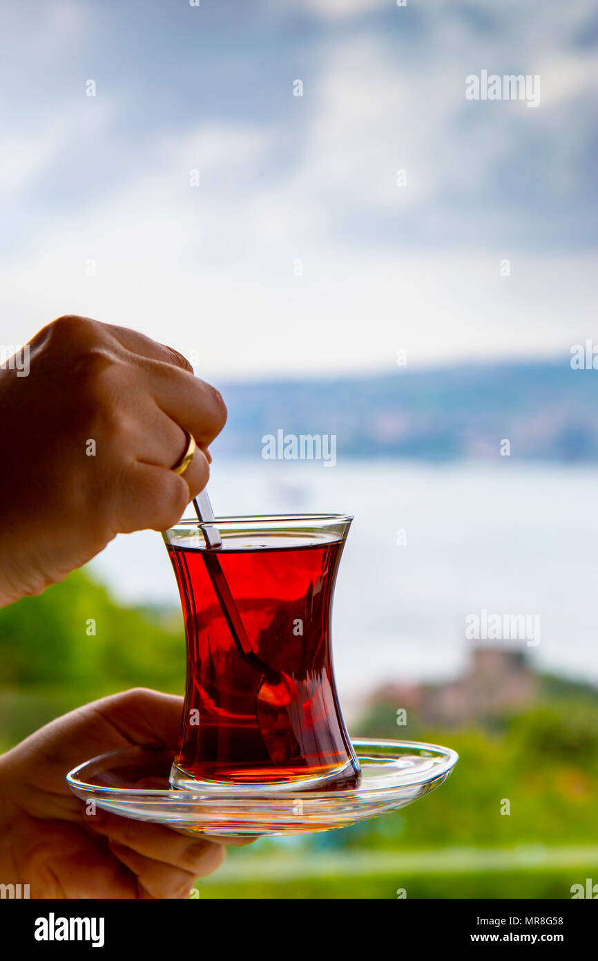 Anonymous hand servicing Turkish Tea Stock Photo - Alamy