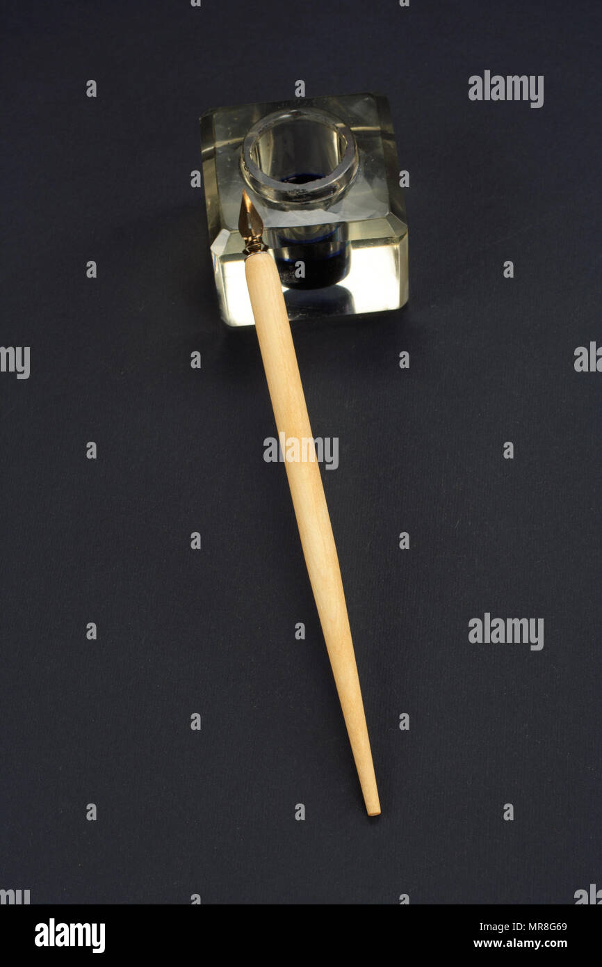 Old fountain pen and inkwell on a black textured background Stock Photo ...