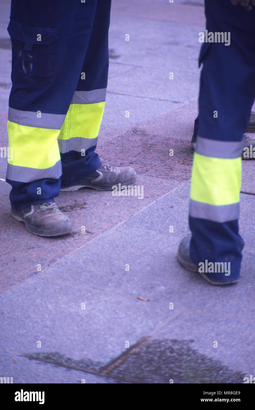 Municipal workers on sidewalk pavement standing in work uniform with ...